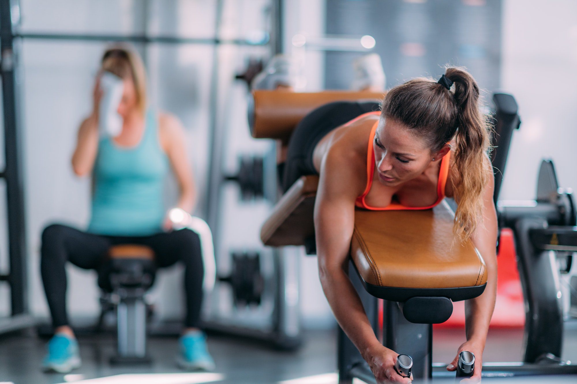 Female Athlete Exercising at Lying Leg Curl Bench in The Gym – Club 24 ...